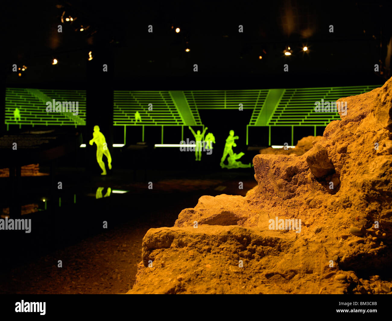 neon figures in a roman underground display featuring remains of ...