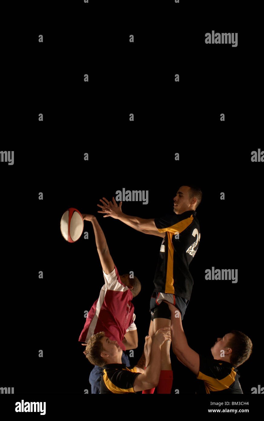 Rugby players competing for ball in air Stock Photo - Alamy