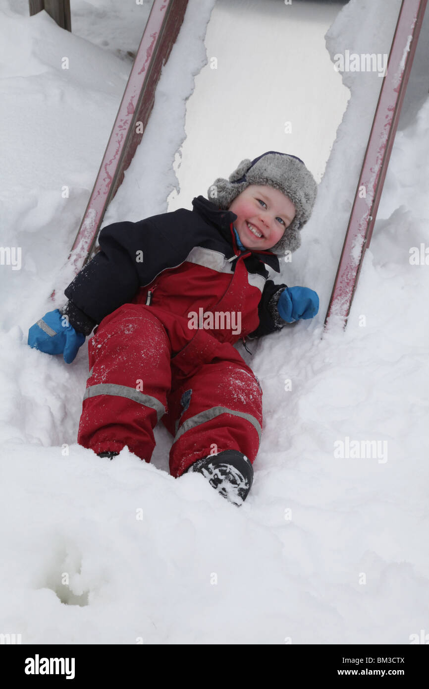 TODDLER BABY BOY PLAYING ON A SLIDE IN DEEP WINTER: A two year old baby ...