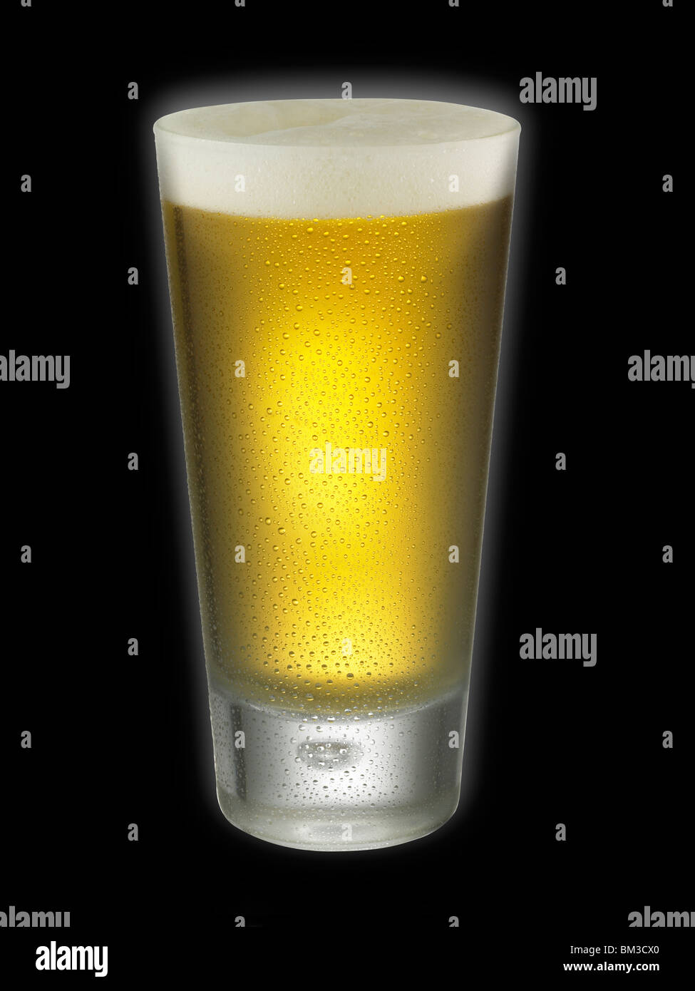 Pint of beer with condensation and perfect head on a black background ...