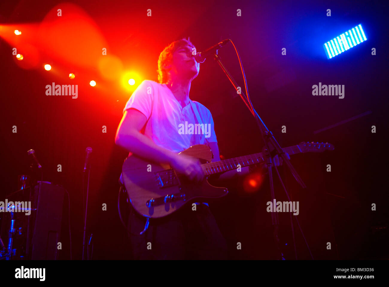 Guitarist singing on stage Stock Photo - Alamy