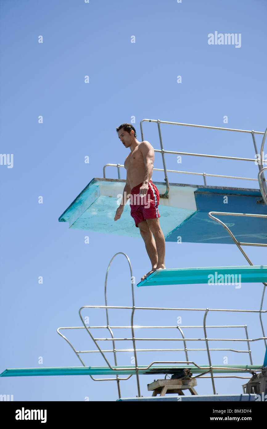 Man standing on a spring board Stock Photo - Alamy