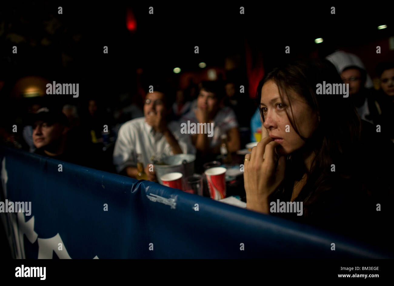 A woman watches a boxing bout in Mexico City, December 9, 2009 Stock ...