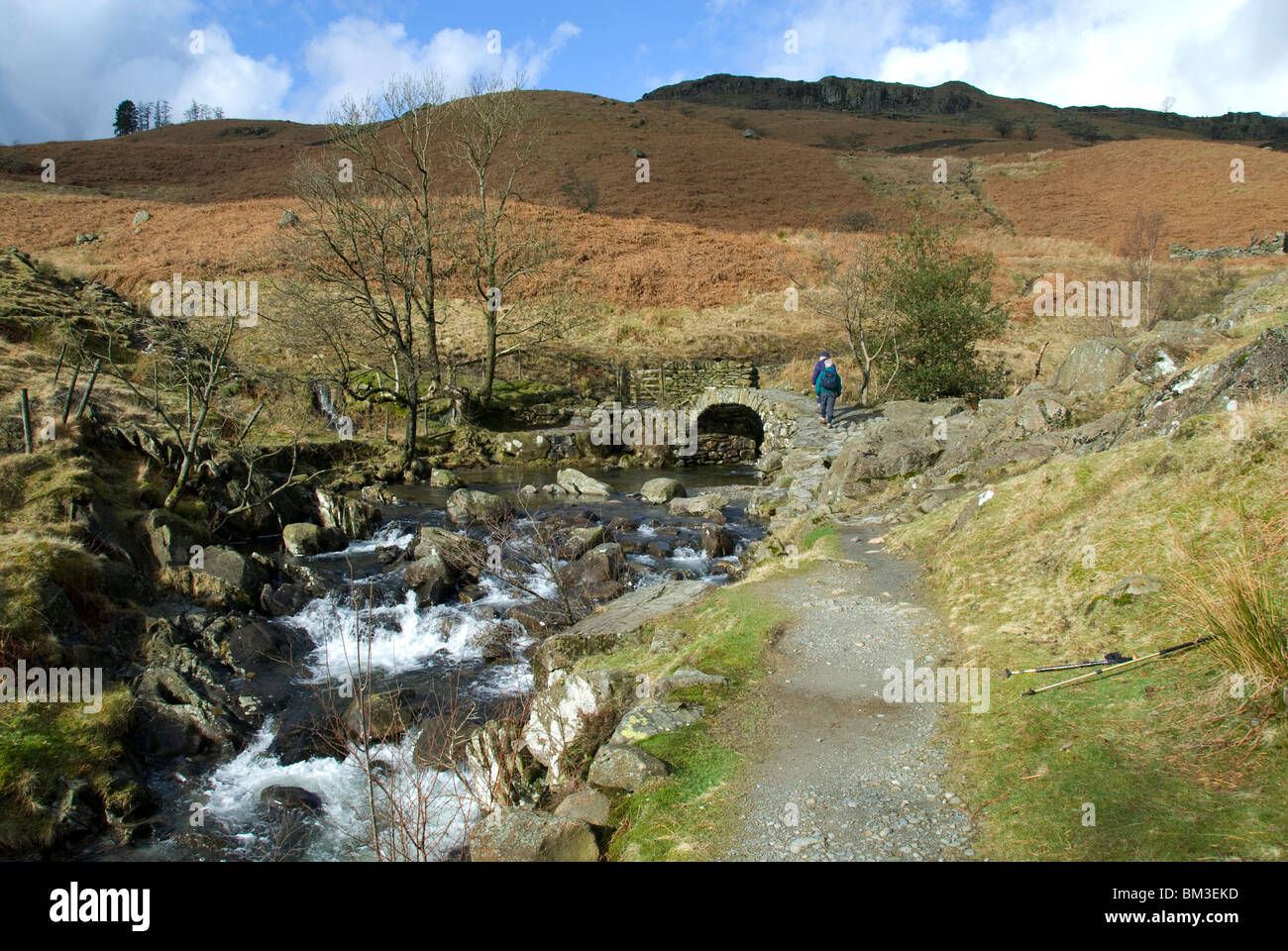 Walkers on High Sweden Bridge, a packhorse bridge over Scandale Beck ...