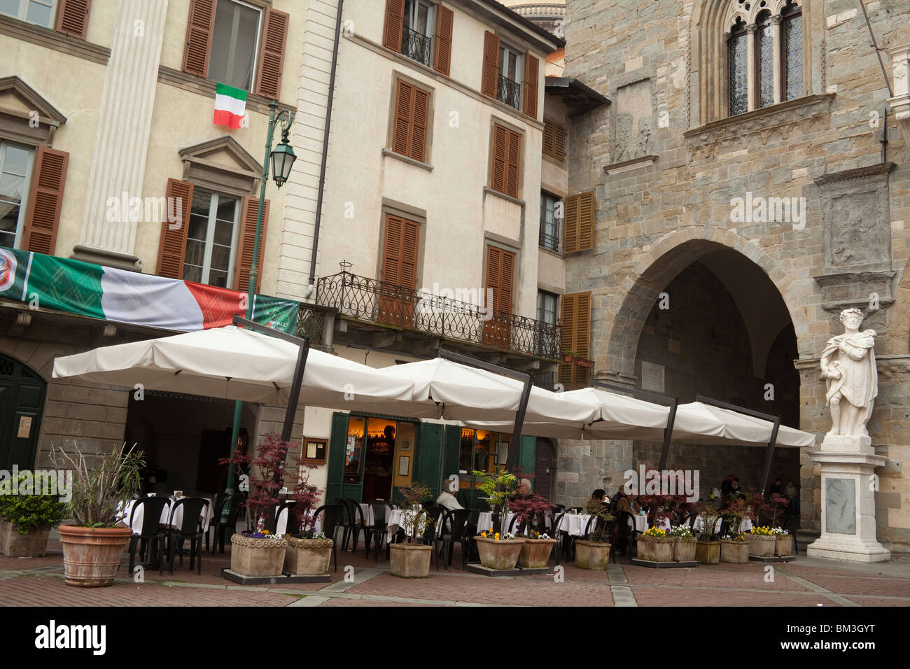 Italy arch sculpture corner restaurant outside classical italian flag ...