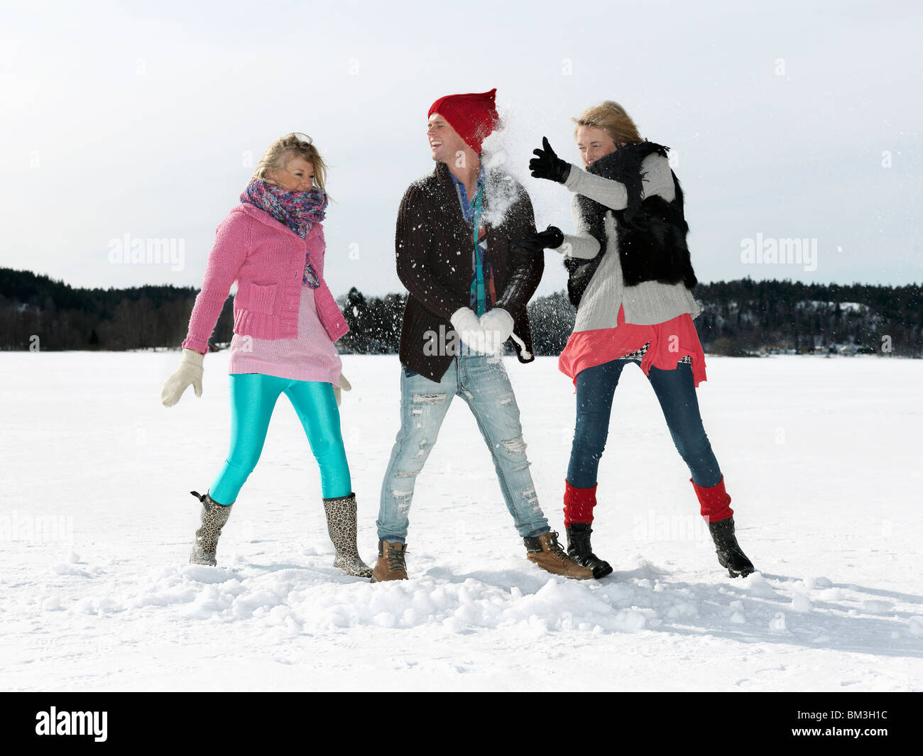 Friends having snow war Stock Photo - Alamy