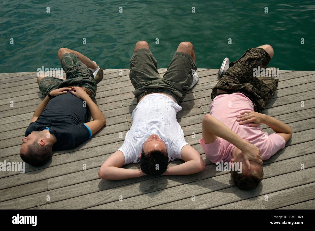 young men lying down for a rest Stock Photo - Alamy