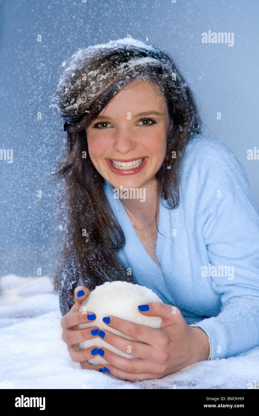 Young woman portrait holds snowball Stock Photo - Alamy