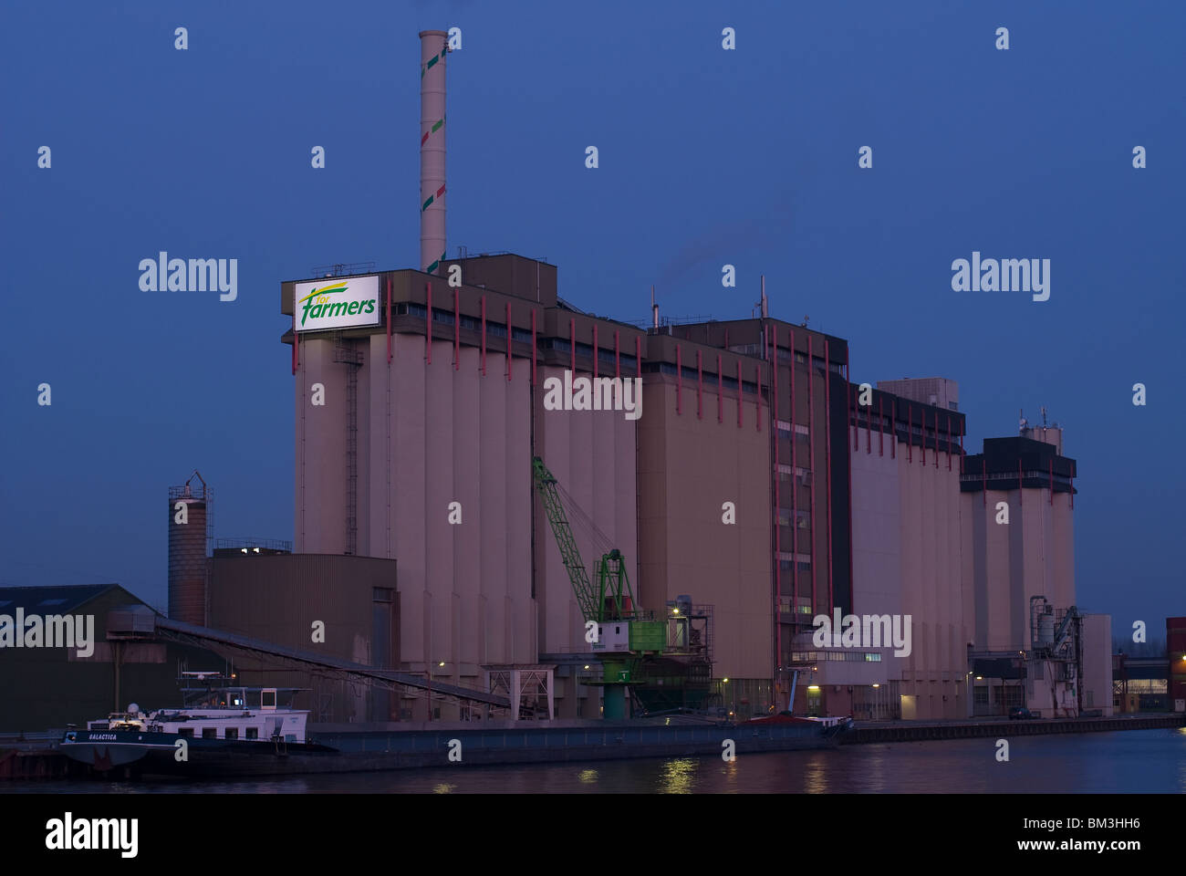 Cargo ship in front of an industrial building ready to be loaded Stock ...