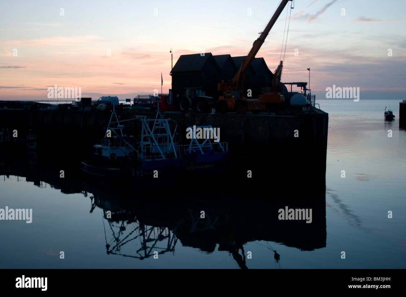 silhouette of whitstable harbour at Sunset Whitstable beach Kent ...