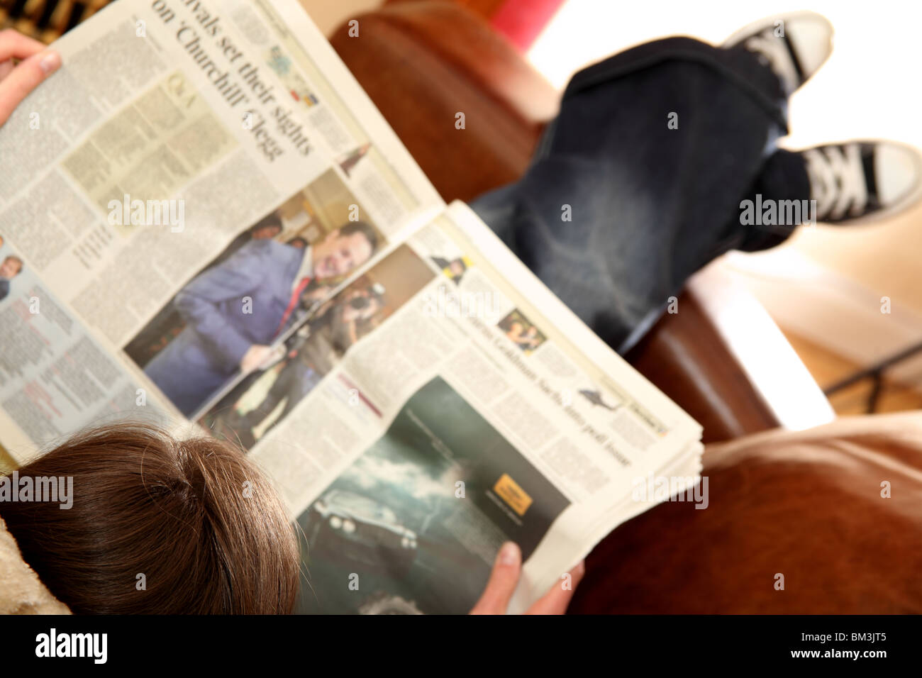 teenager reading the newspaper Stock Photo - Alamy