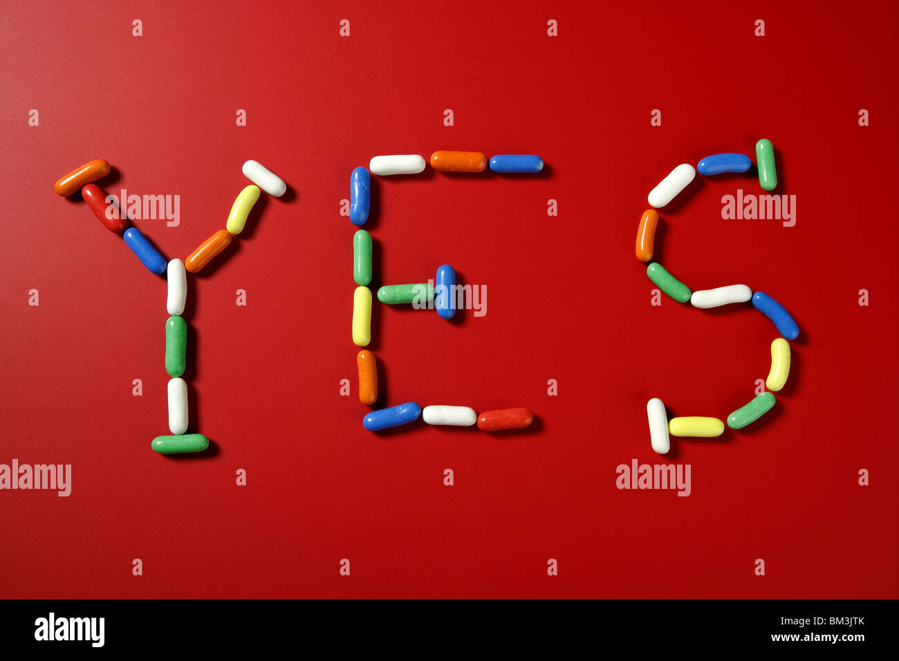 Candy colorful sweets with letter shapes spelling the word YES, over ...