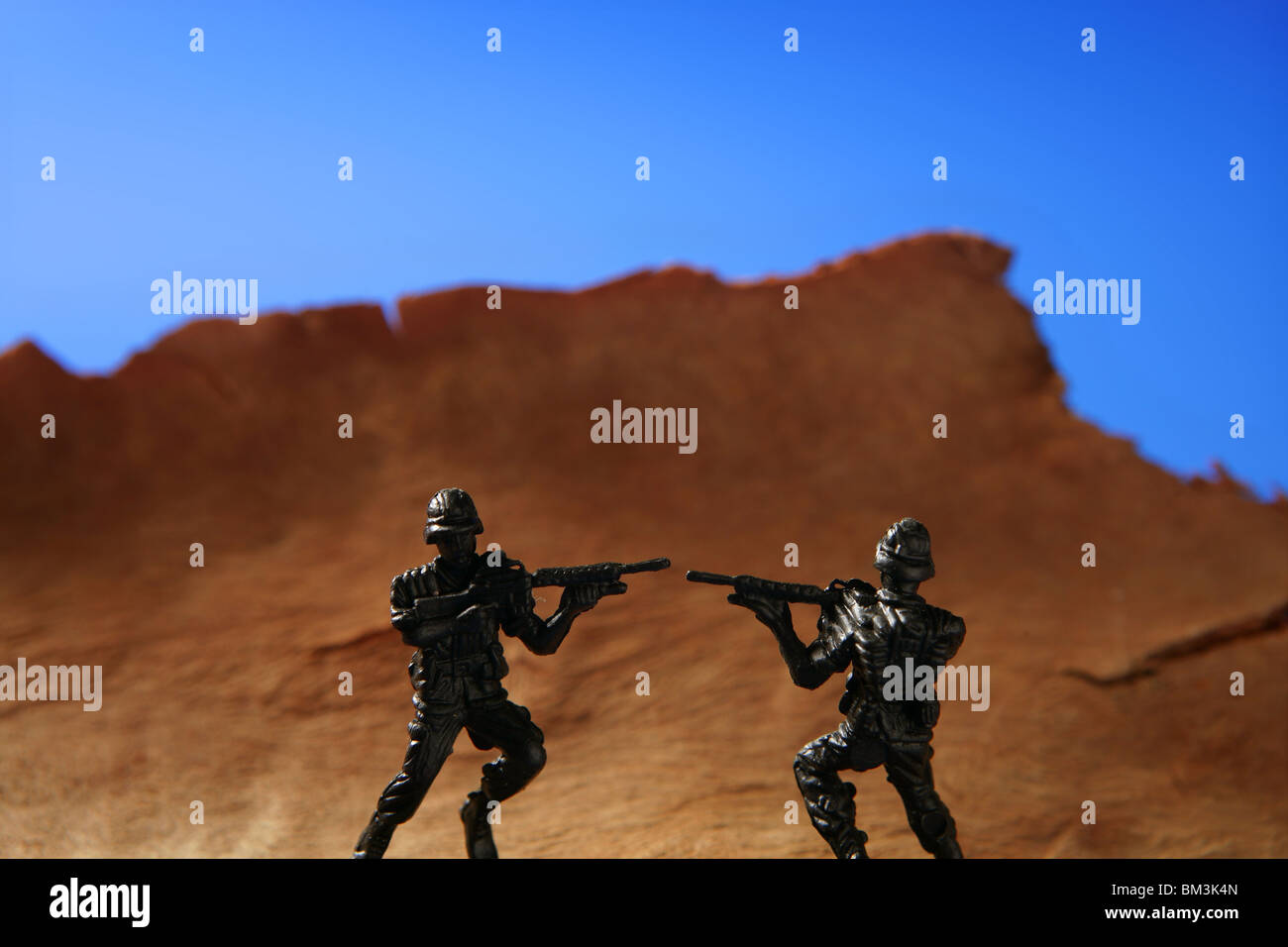 War metaphor, toy little soldiers fighting on wooden mountain Stock ...