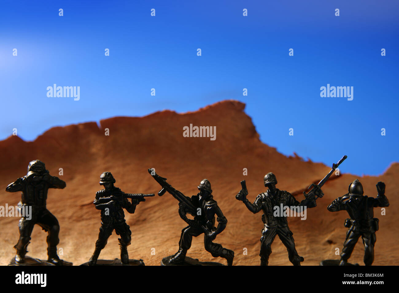 War metaphor, toy little soldiers fighting on wooden mountain Stock ...