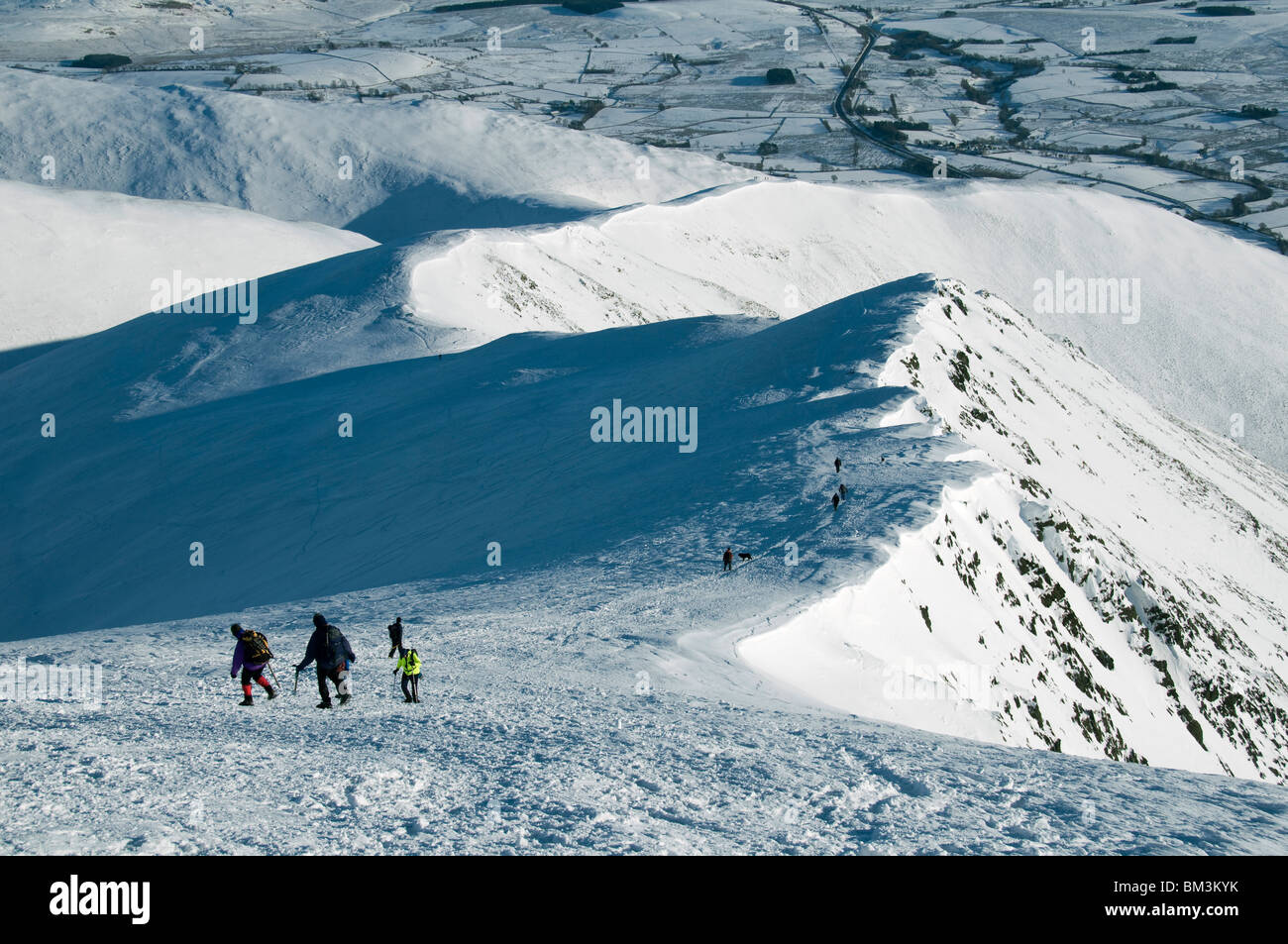Walkers on the Scales Fell ridge of Blencathra in winter, Lake District ...