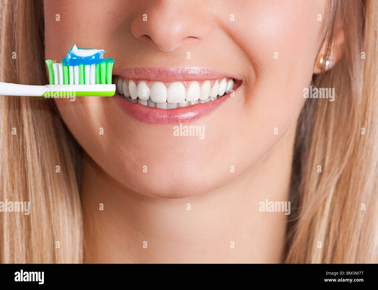 Woman cleaning teeth Stock Photo - Alamy