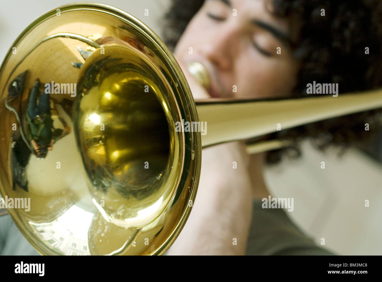 Young man playing the trombone Stock Photo - Alamy
