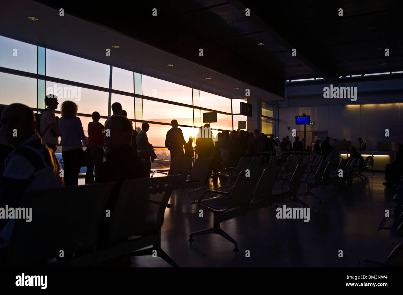 Passengers queue to board a flight at Terminal One Stock Photo - Alamy