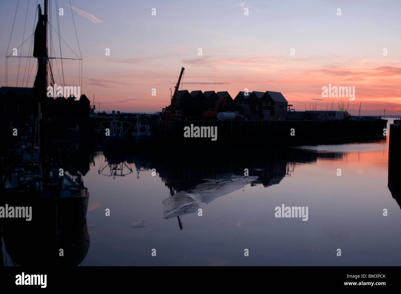 silhouette of whitstable harbour at Sunset Whitstable beach kent ...