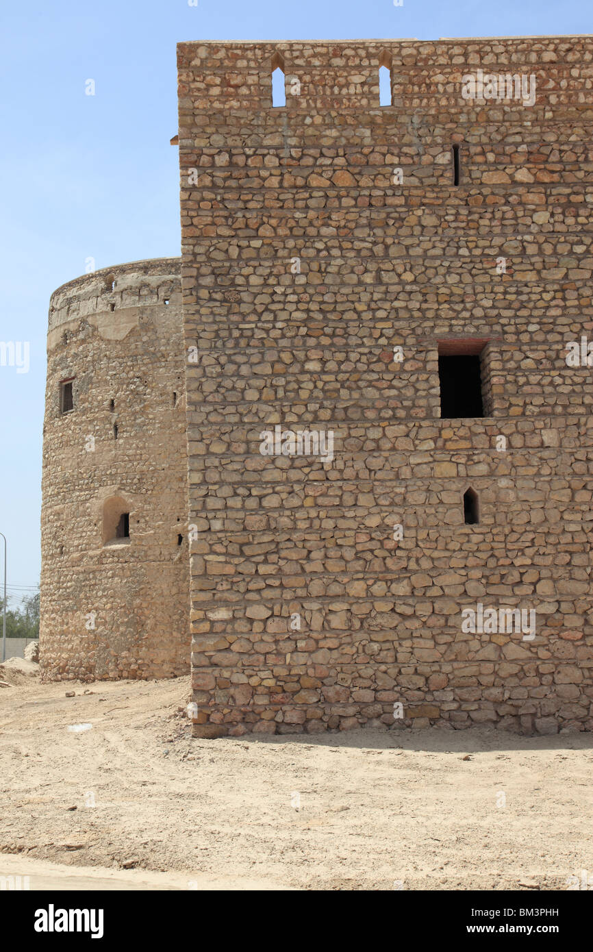 restored tower and outside fortified wall of historicAl-Musanah Castle ...