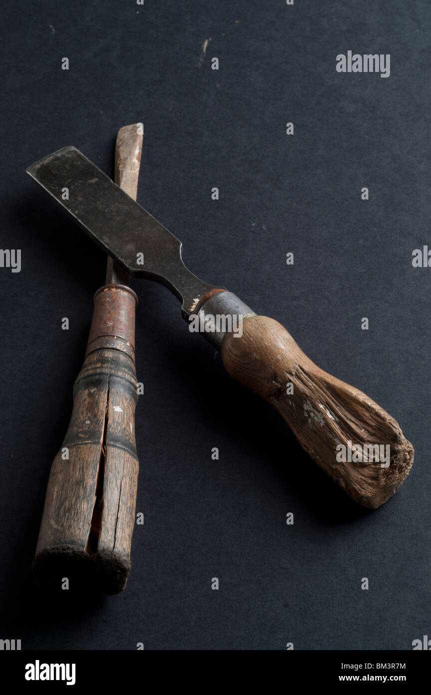 old worn screwdriver and chisel on black Stock Photo - Alamy