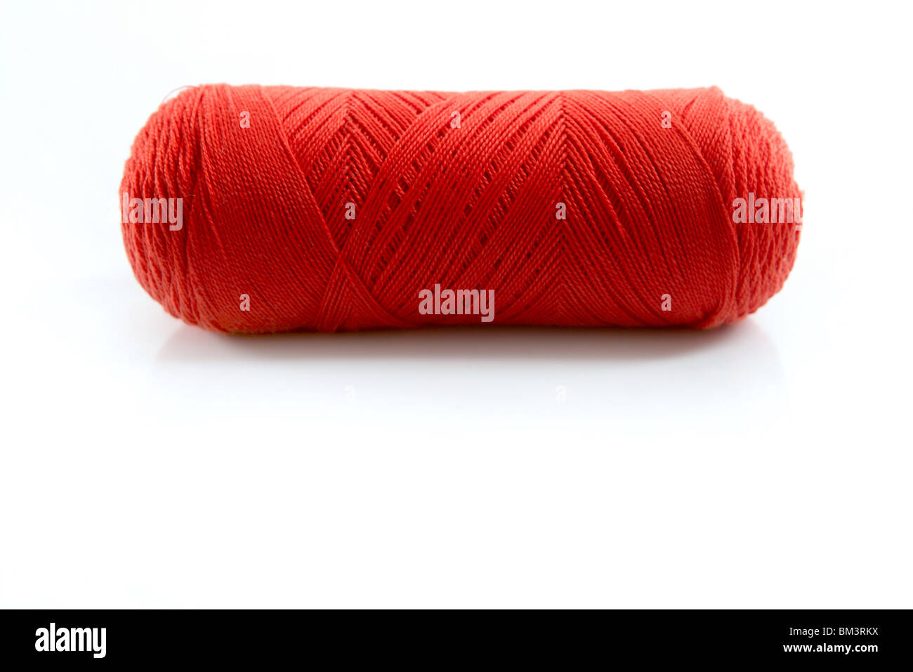 Red thread spool isolated over white studio background Stock Photo - Alamy