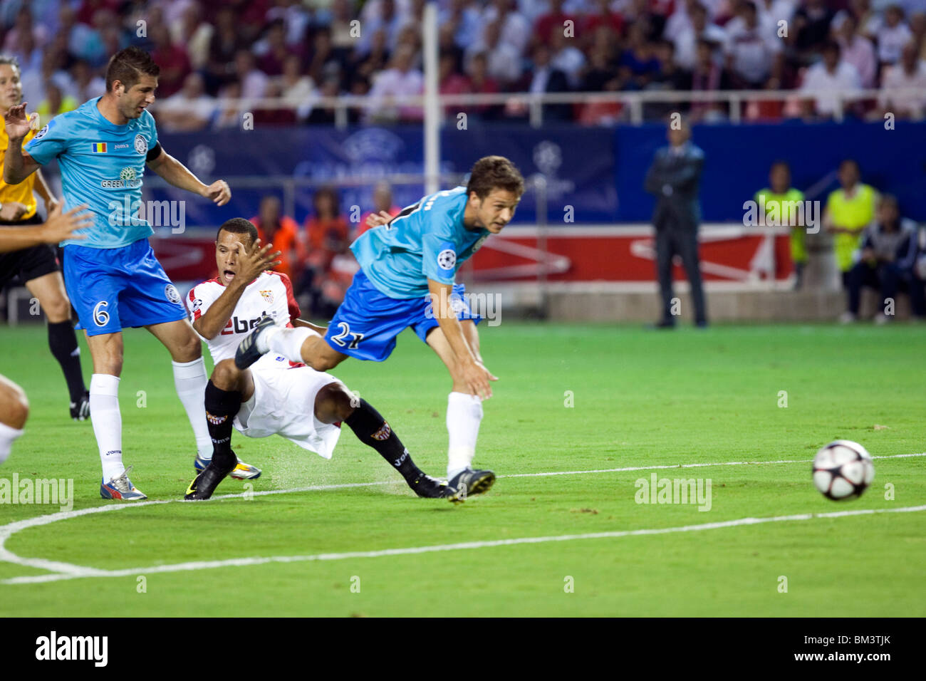 Luis Fabiano falls between George Galamaz (left) and Tiberiu Balan ...