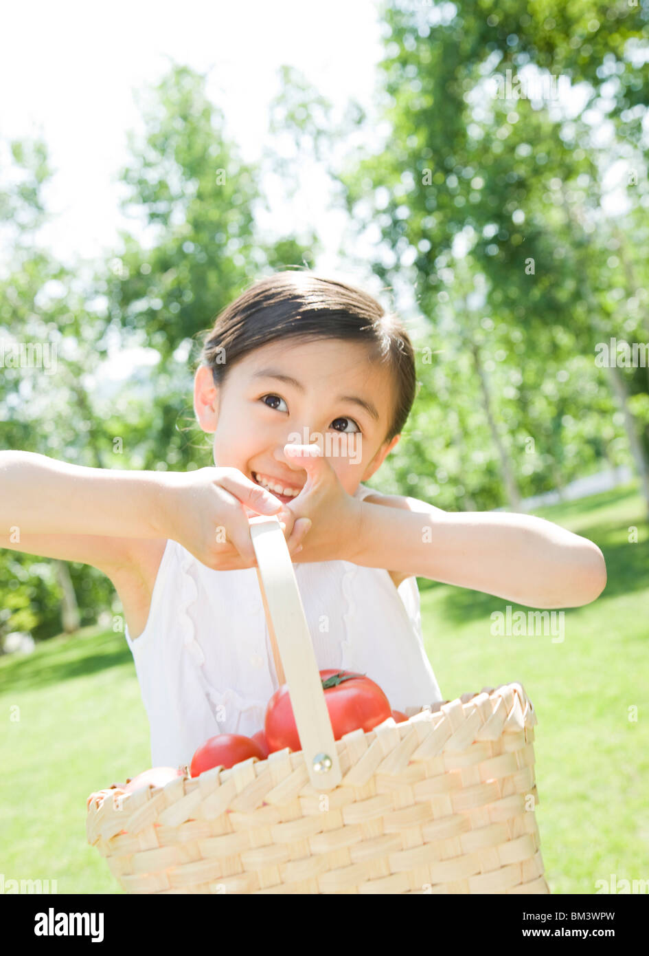 A Girl Holding Basket Stock Photo - Alamy