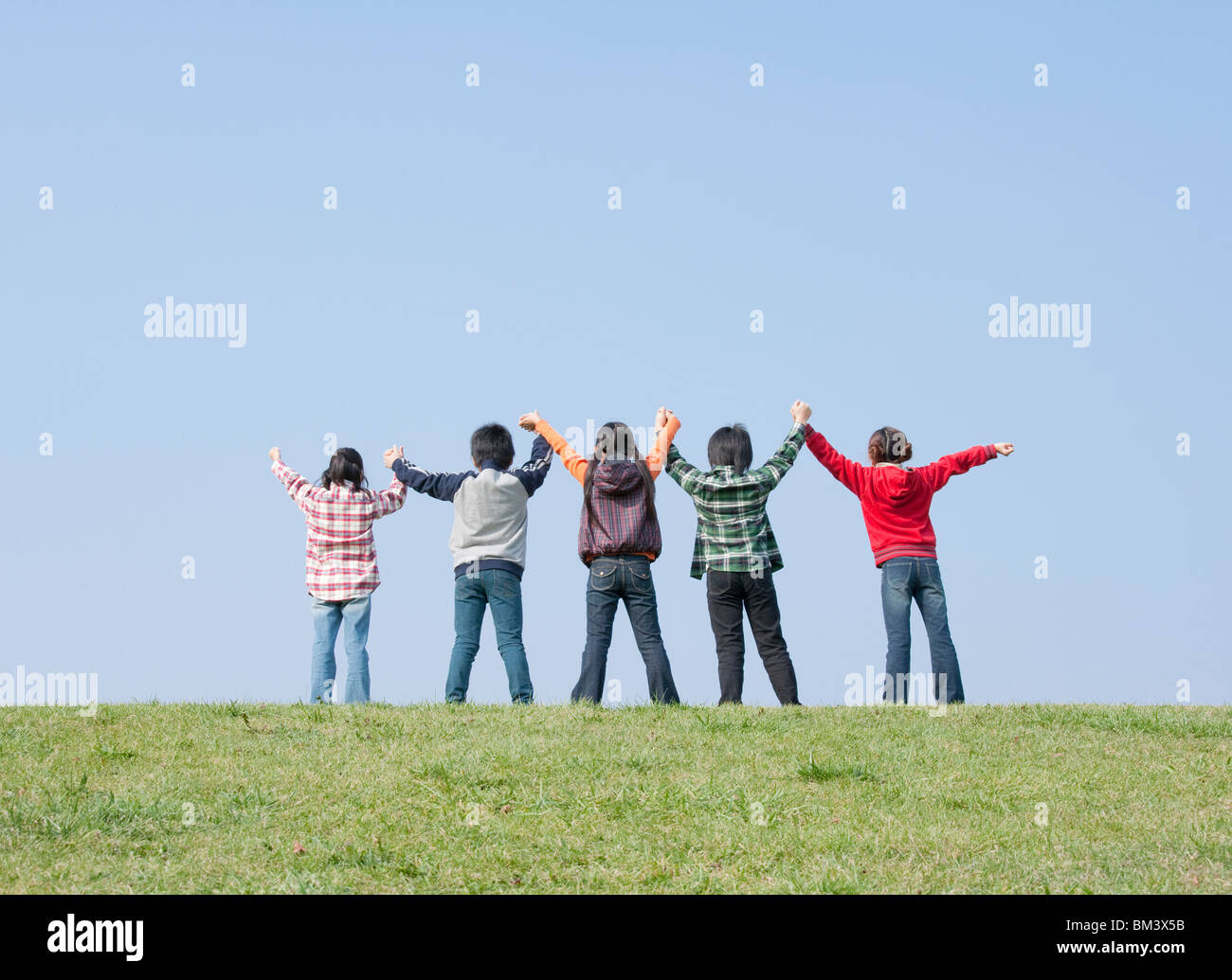 Boys and Girls Holding Hands Up Stock Photo - Alamy