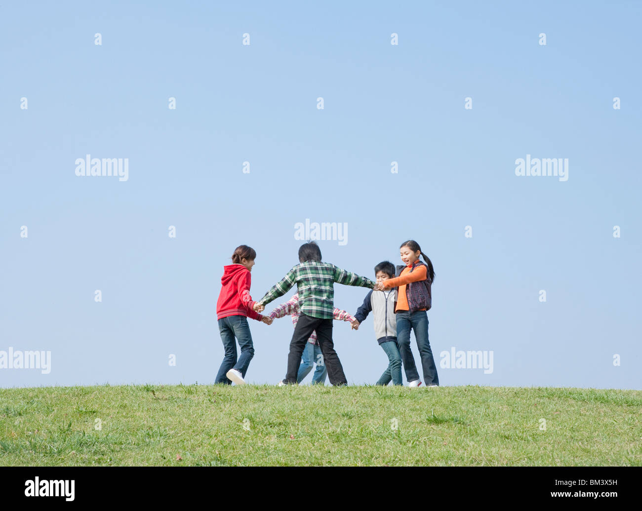 Boys and Girls Holding Hands, Going Around in Circle Stock Photo - Alamy