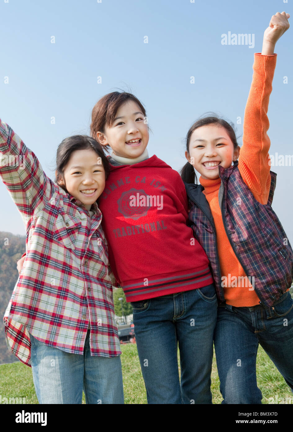 Three Girls Standing in Green Field Stock Photo - Alamy