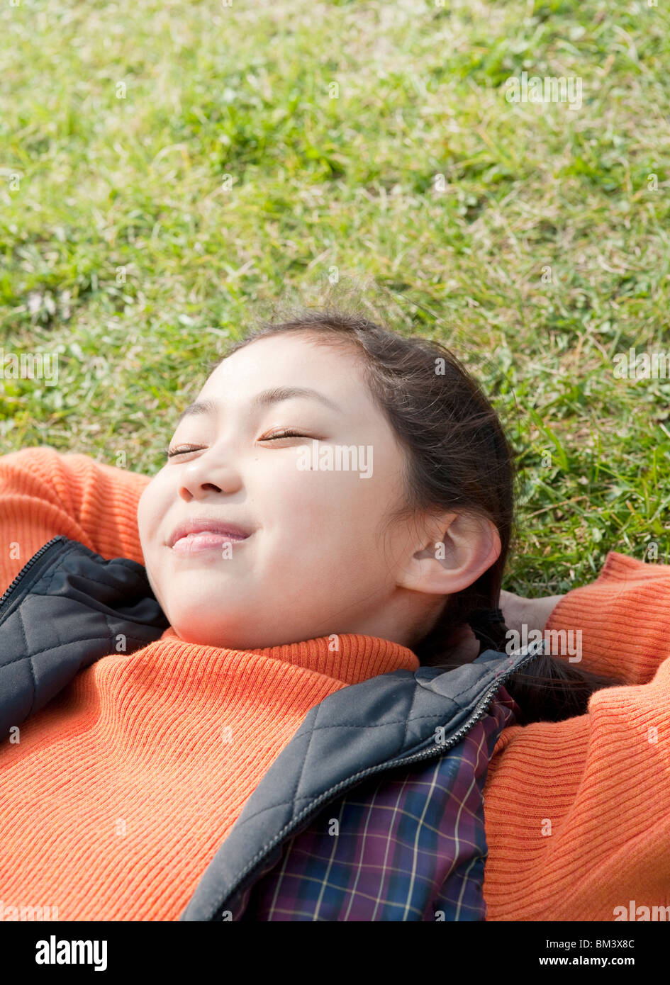 Girl Lying on Green Field Stock Photo - Alamy
