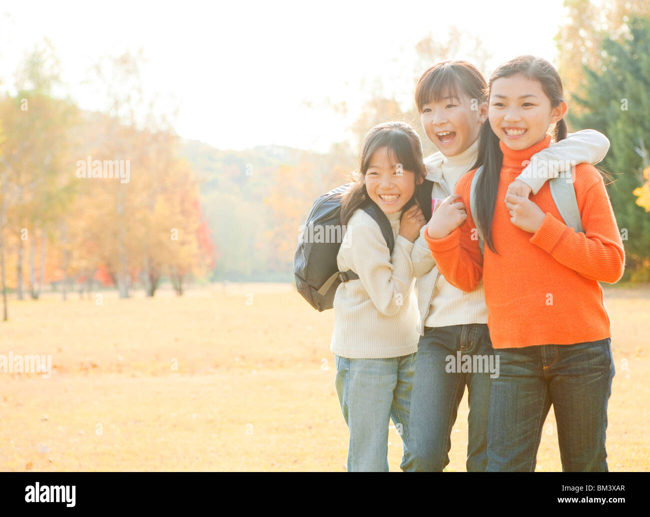 Portrait of Three Girls, Standing in Field, Autumn Color Trees in the ...