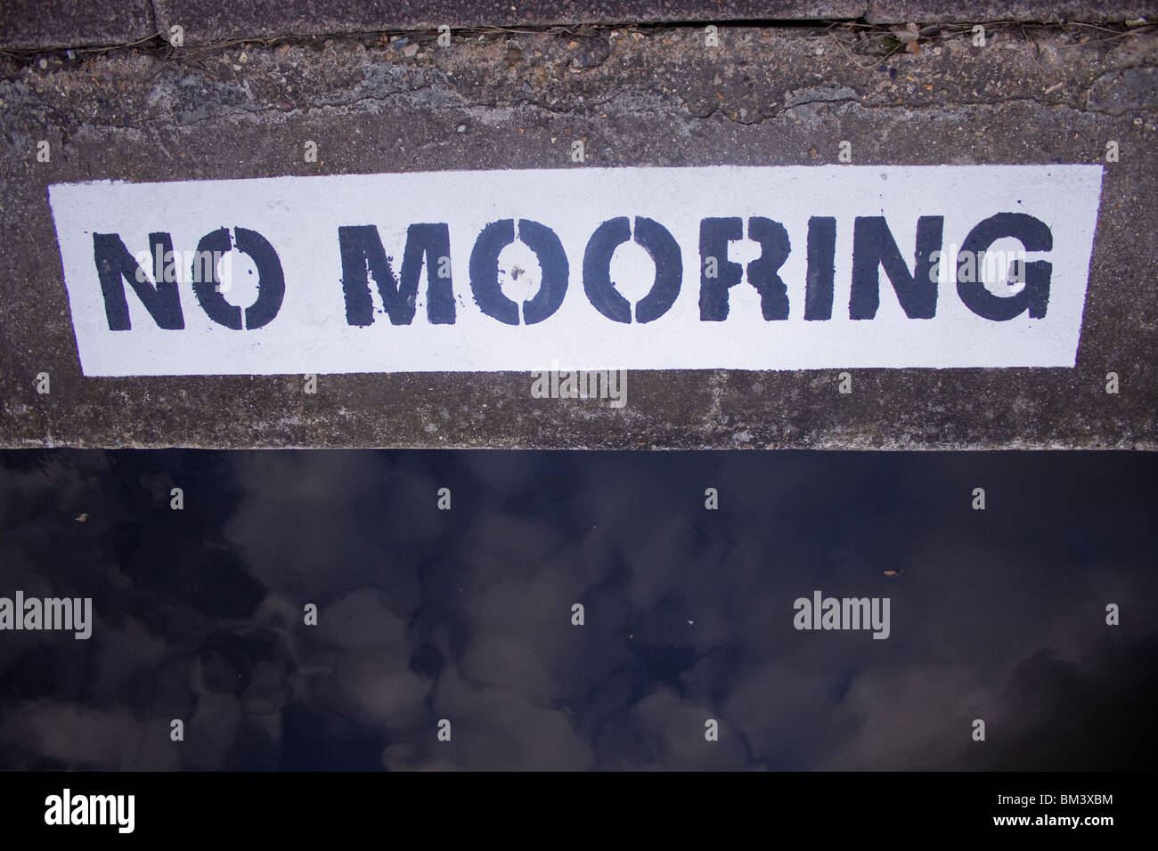 A white and black painted 'No mooring' sign on Camden Lock canal Stock ...