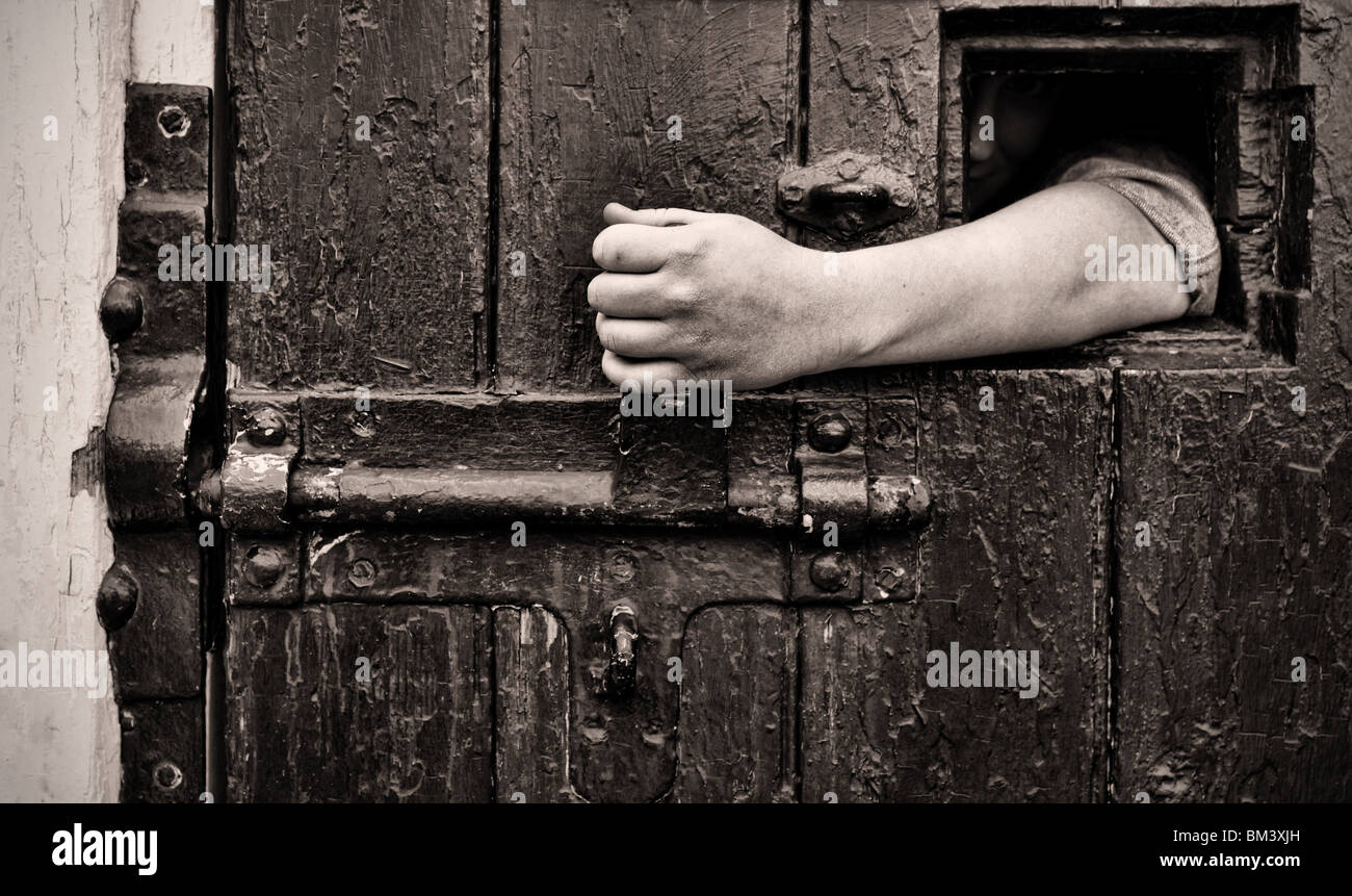 escape arm reaches through jail window to open the door Stock Photo - Alamy