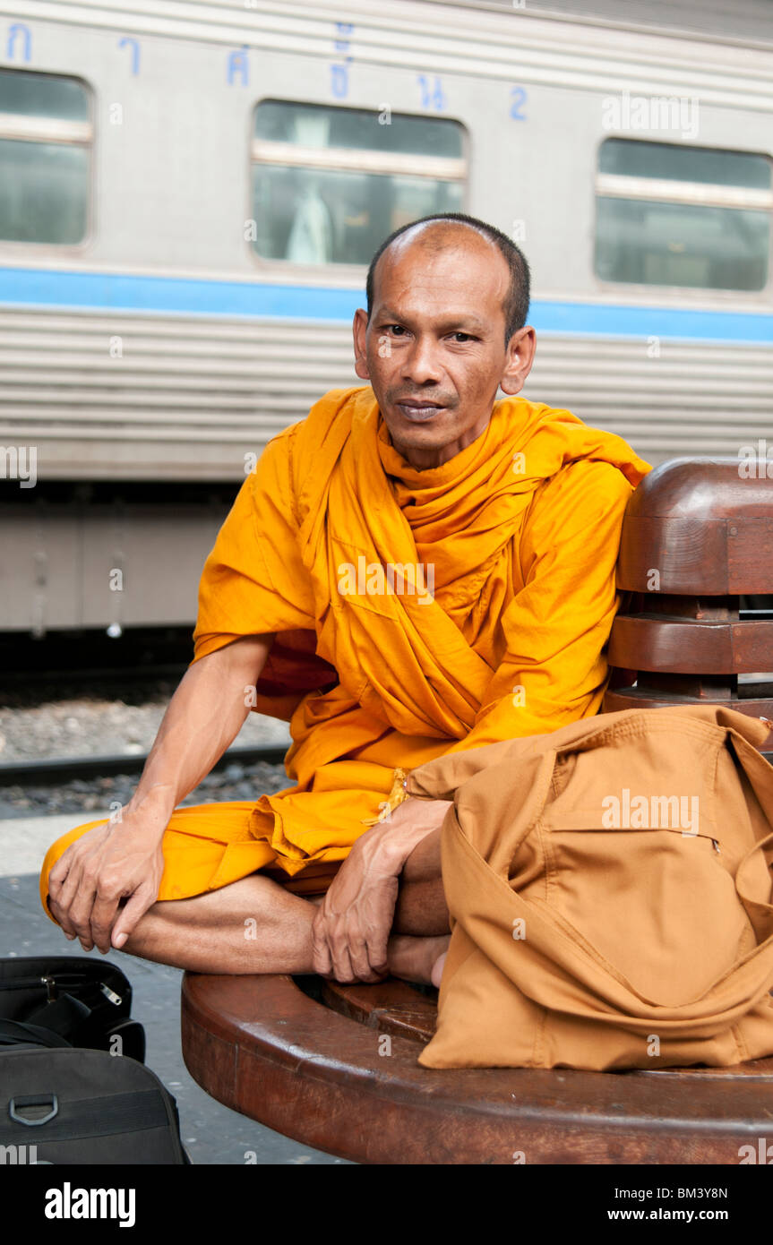 A monk sits cross legged in Bangkok train station Thailand Stock Photo ...
