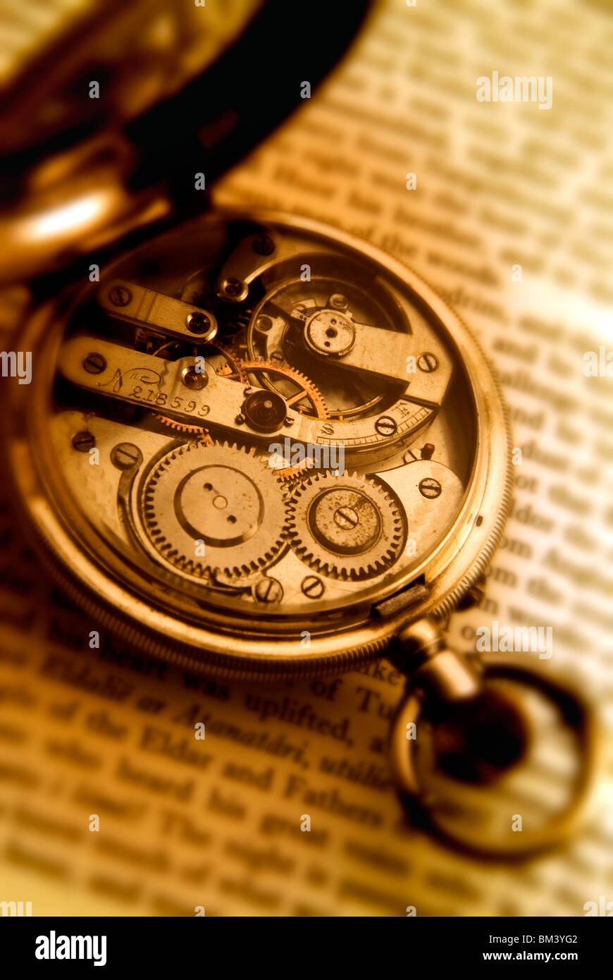 Pocket watch on book Stock Photo - Alamy