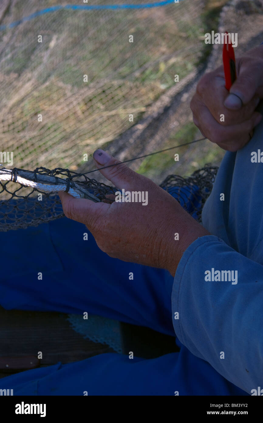 Fisherman fixing nets hi-res stock photography and images - Alamy