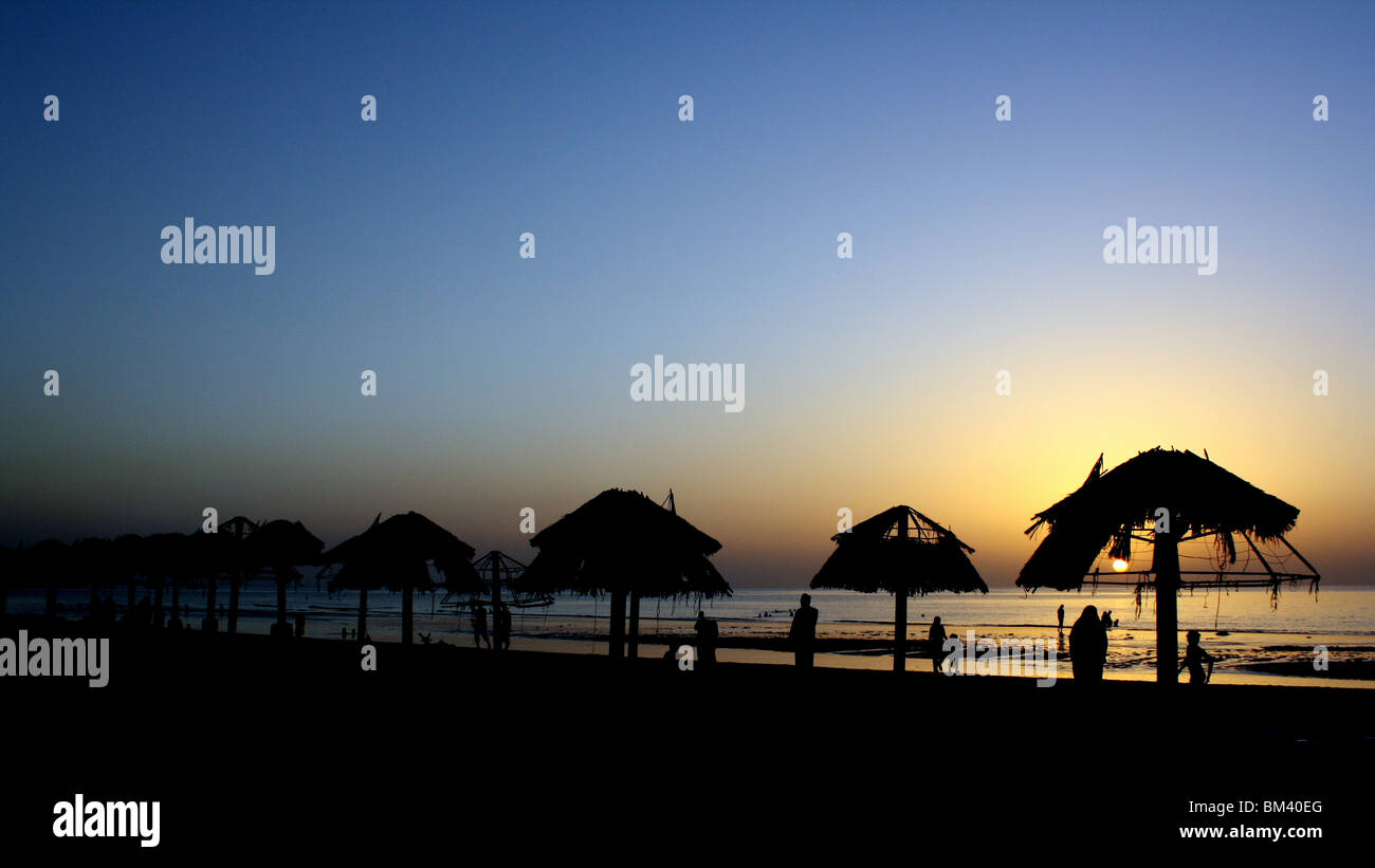 A row of umbrellas by the corniche during sunset in Muscat, Oman Stock ...