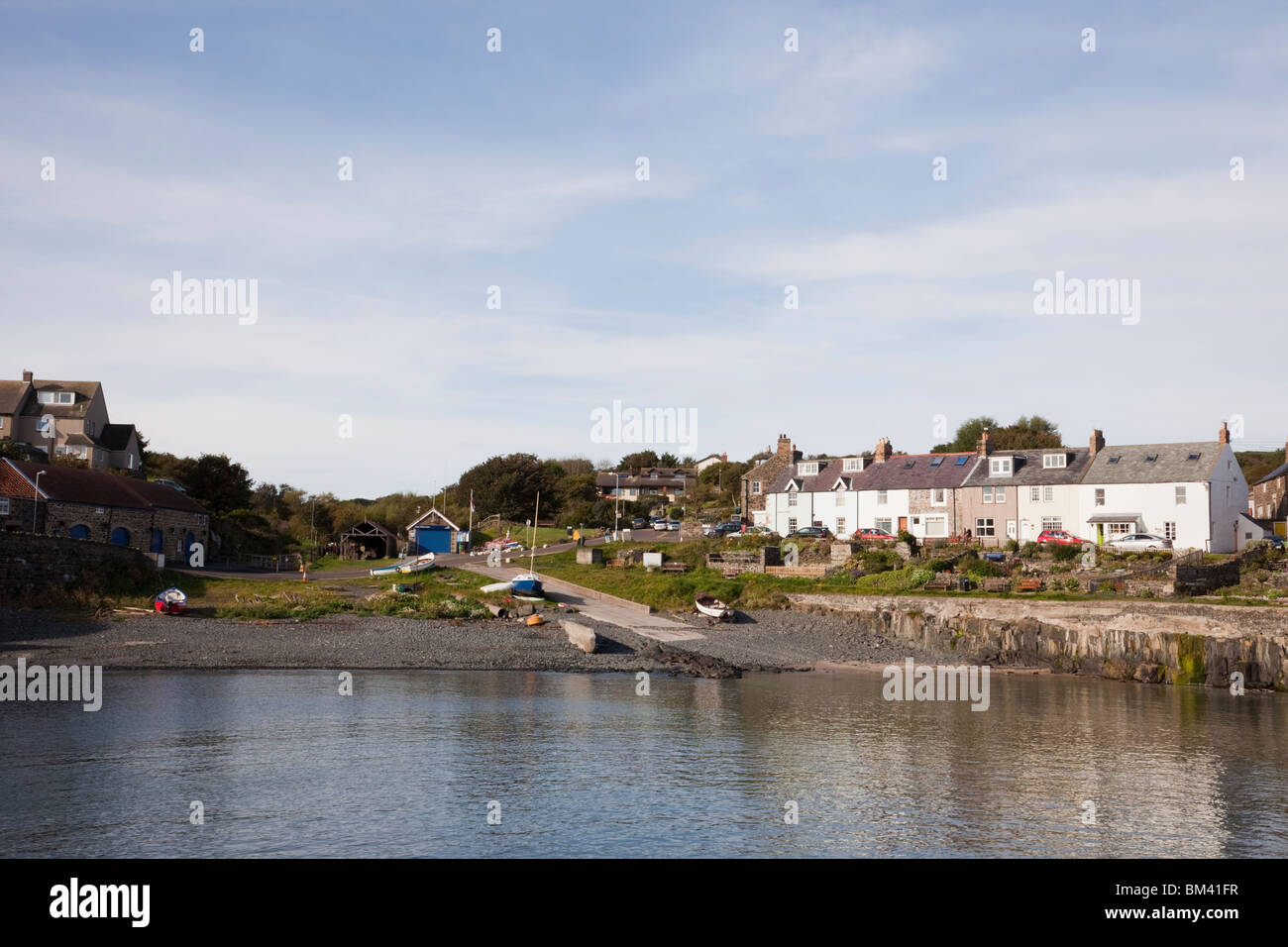 Craster, Northumberland, England, UK. View across the harbour to small ...