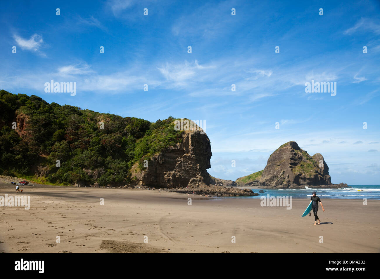 Surfer on the beach. Piha, Waitakere Ranges Regional Park, Auckland ...