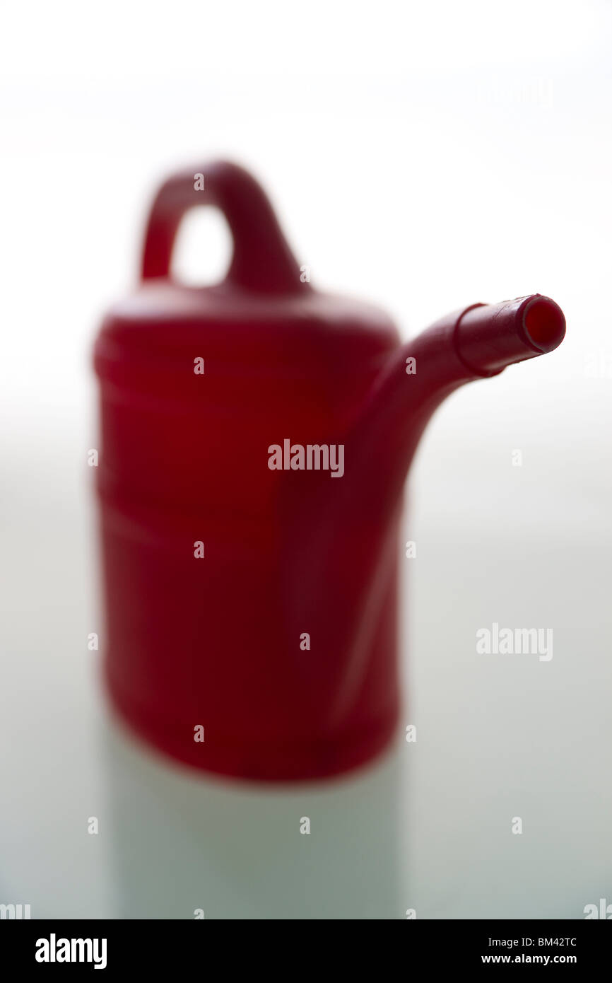 Red Watering can Stock Photo - Alamy