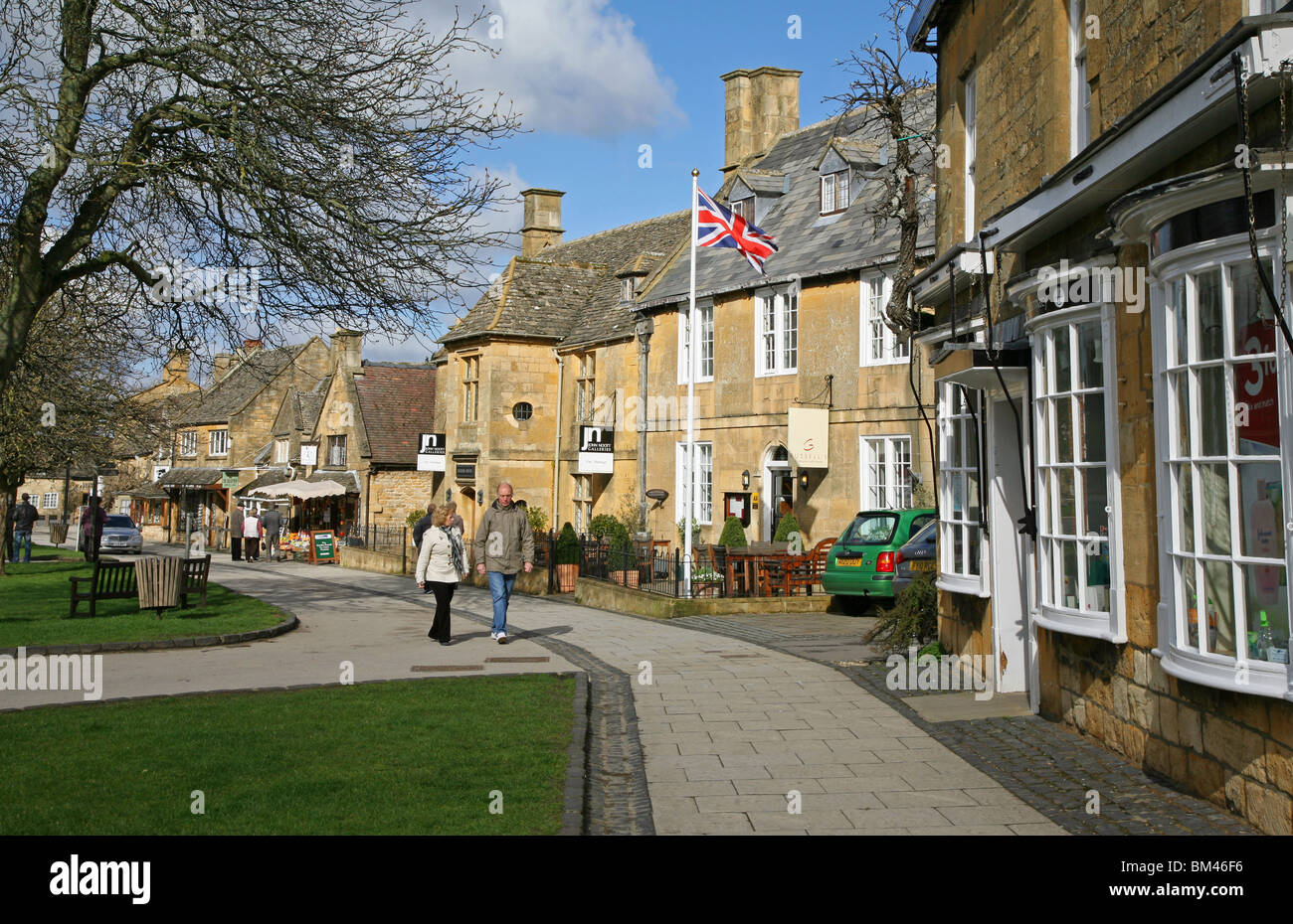 Attractive shops built of warm Cotswold stone line the main street in ...