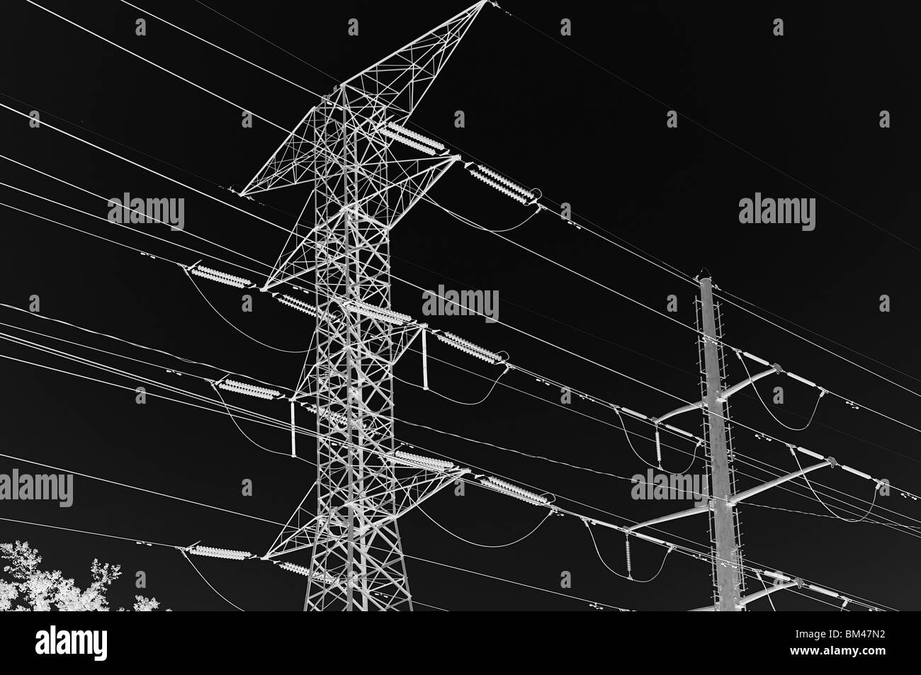 High voltage transmission lines and tower inverted Stock Photo - Alamy