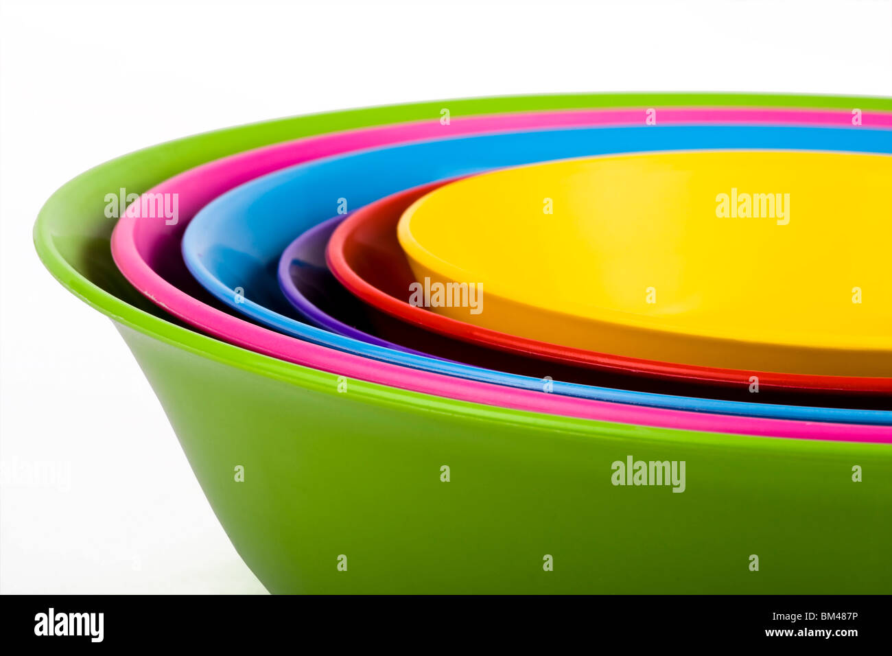 Stack of colorful plastic bowls over white background Stock Photo - Alamy