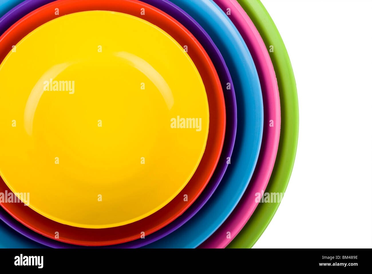 Stack of colorful plastic bowls over white background Stock Photo - Alamy