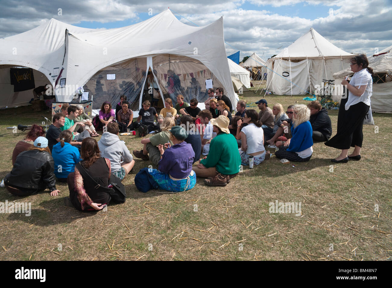 An open-air environmental discussion taking place in a circle at the ...