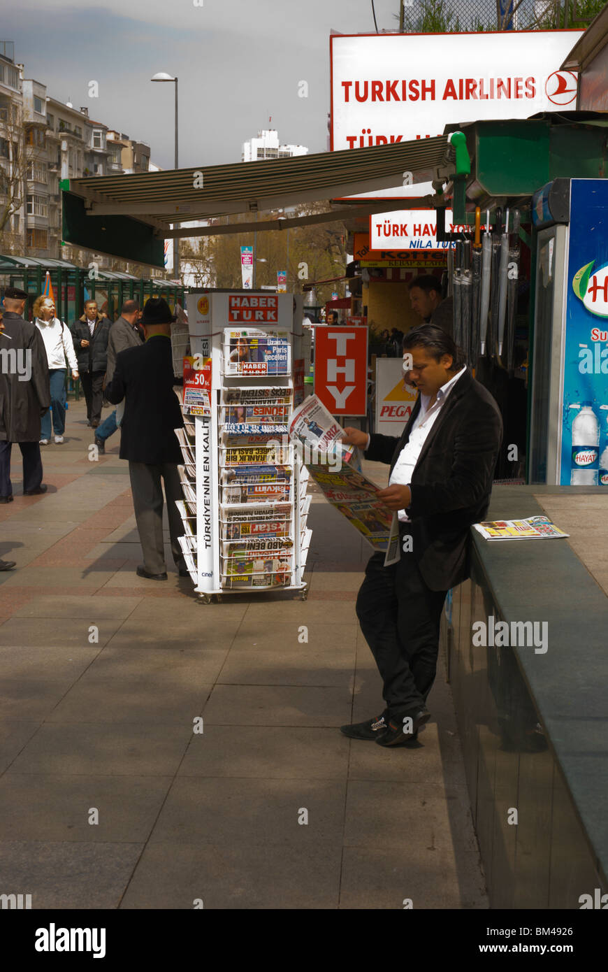 Man reading newspaper Taksim square Istanbul Turkey Europe Stock Photo ...