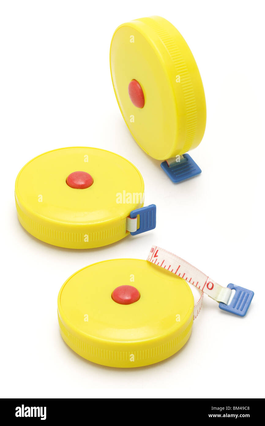 Three yellow plastic measuring tapes on white background Stock Photo ...