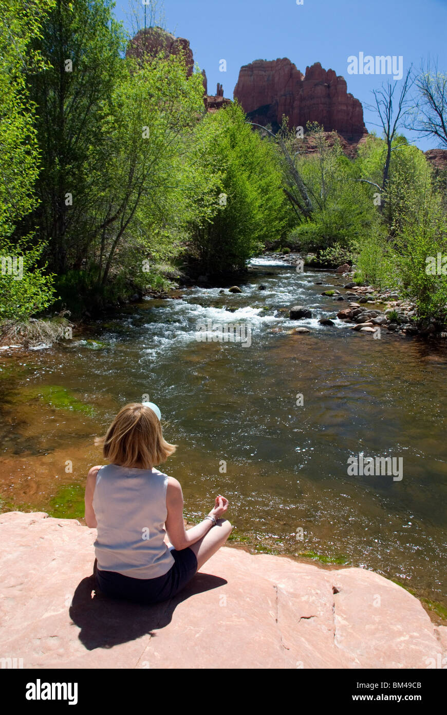 Woman meditating on a vortex point Oak Creek River Red Rock State Park ...
